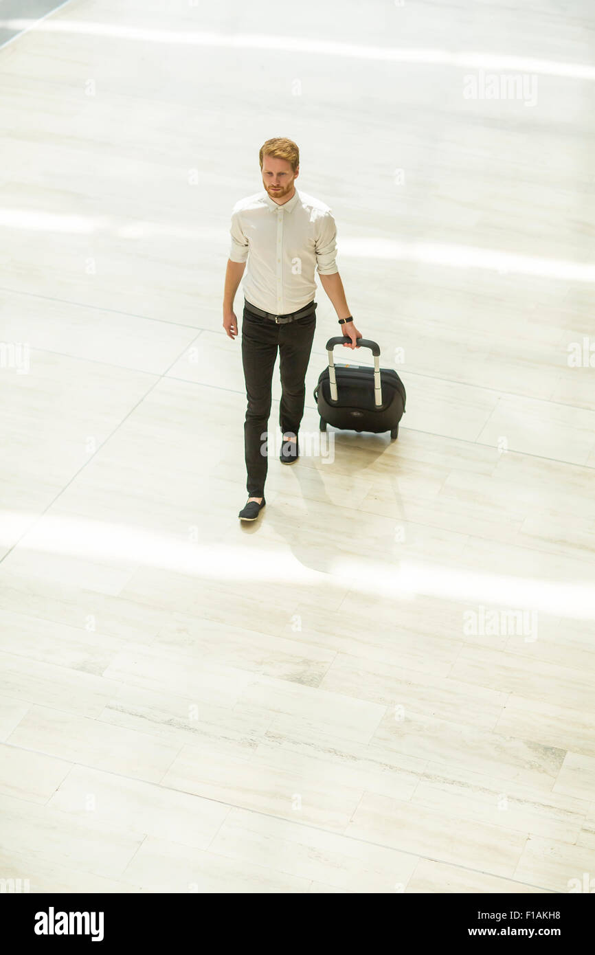 Young man with suitcase Stock Photo - Alamy