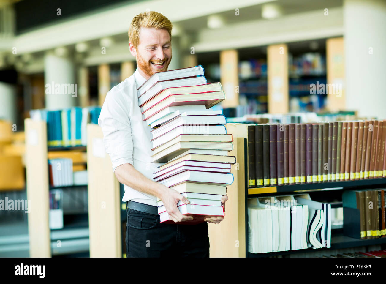 Young man in the library Stock Photo - Alamy