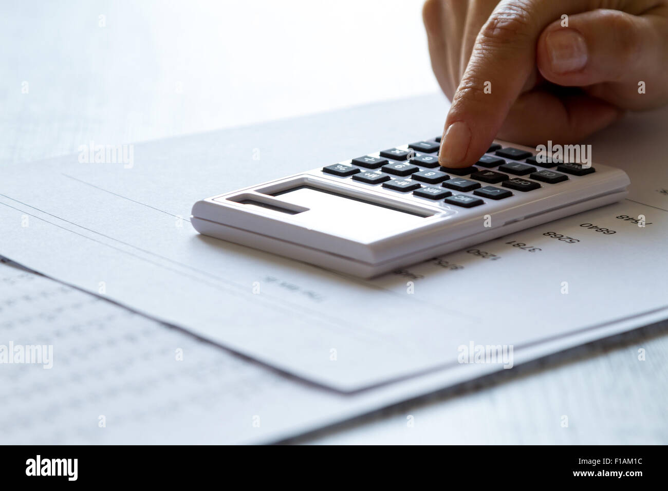 Analyzing numbers and doing calculations at the office Stock Photo - Alamy