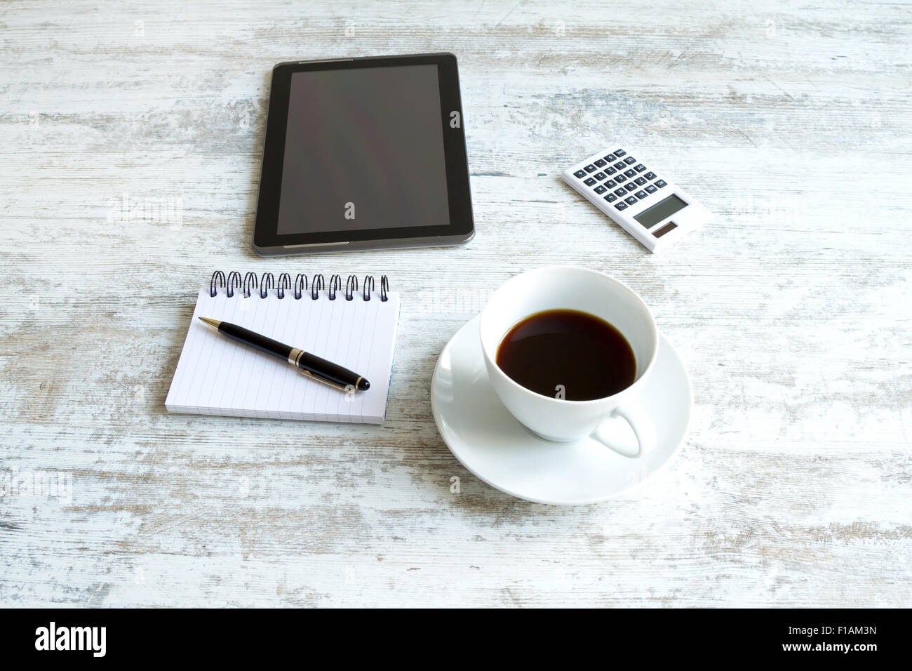 Working at the office, taking notes and using the tablet Stock Photo ...