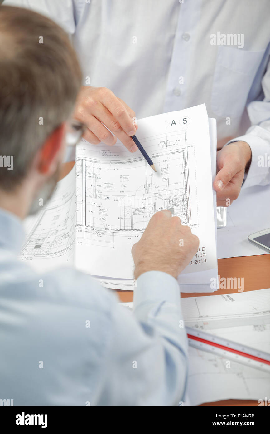 Two men discussing blueprints Stock Photo - Alamy