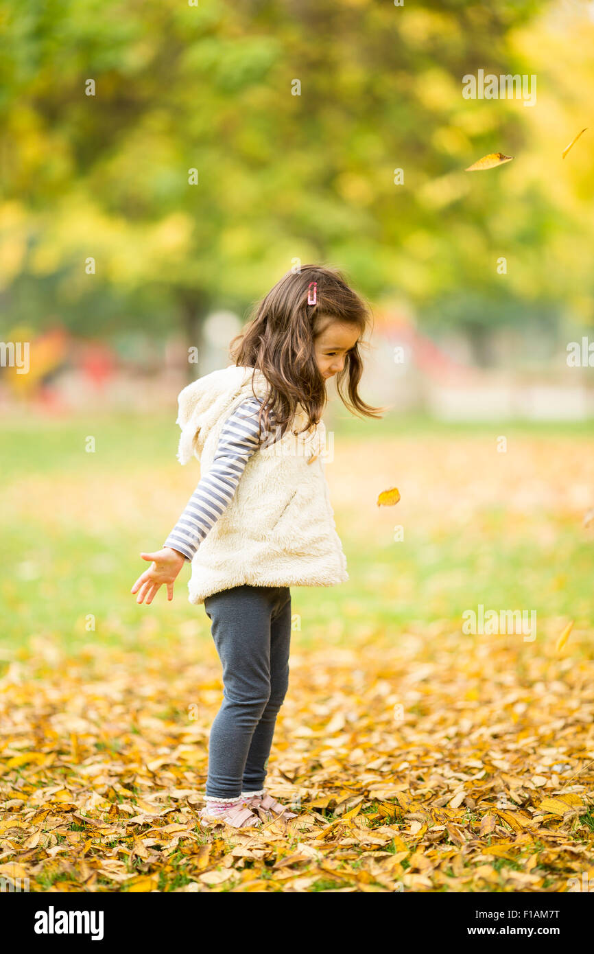 Little girl at the autumn park Stock Photo - Alamy