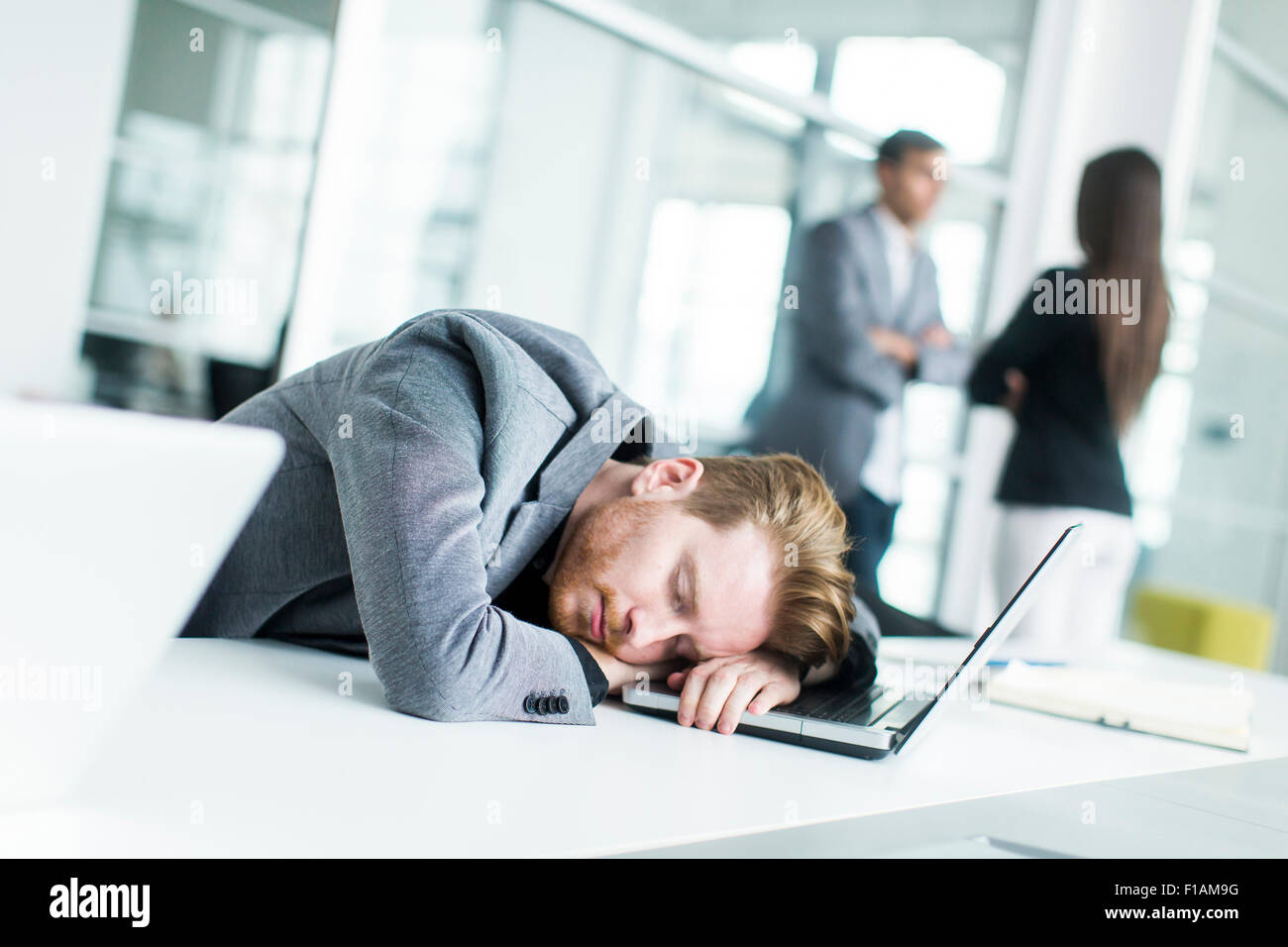 Tired young man sleeping in the office Stock Photo - Alamy