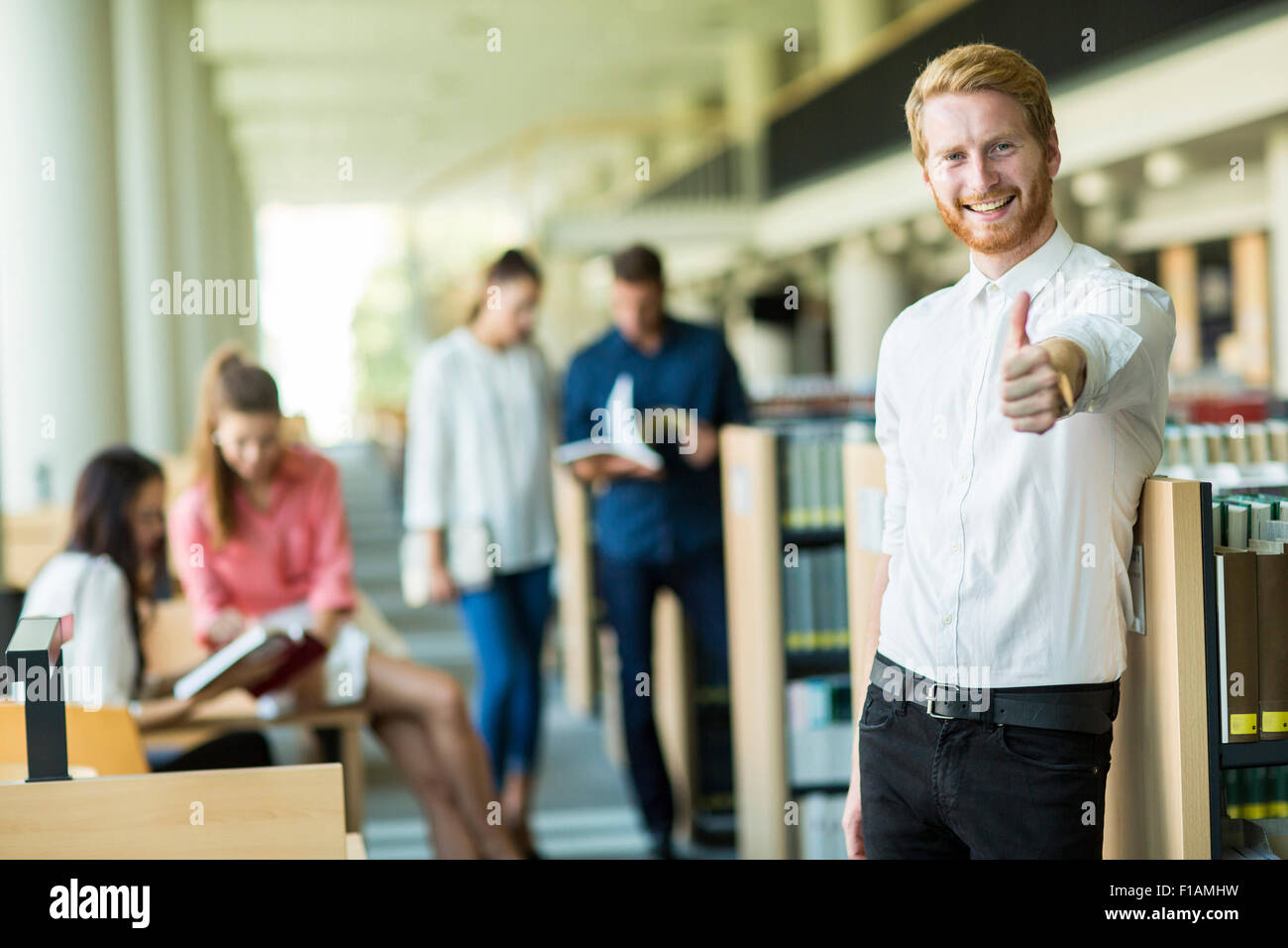 Young man in the library Stock Photo - Alamy