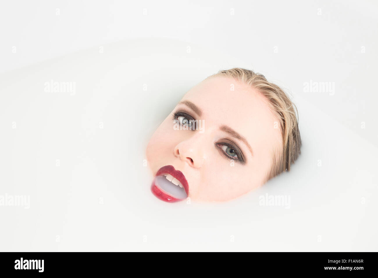 Young woman in milk bath Stock Photo - Alamy