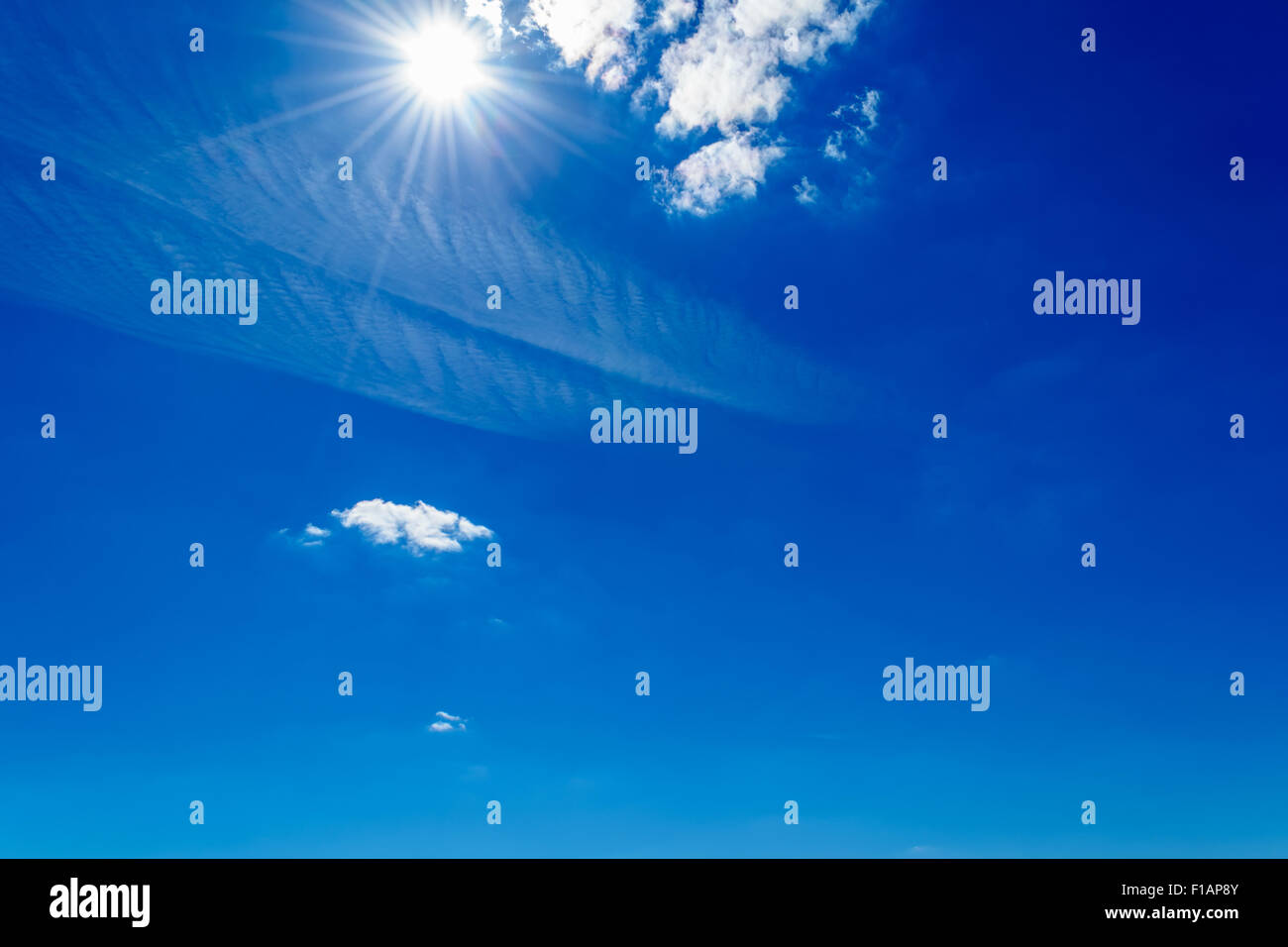 Bright sun shining in the blue sky with clouds on summer day Stock ...