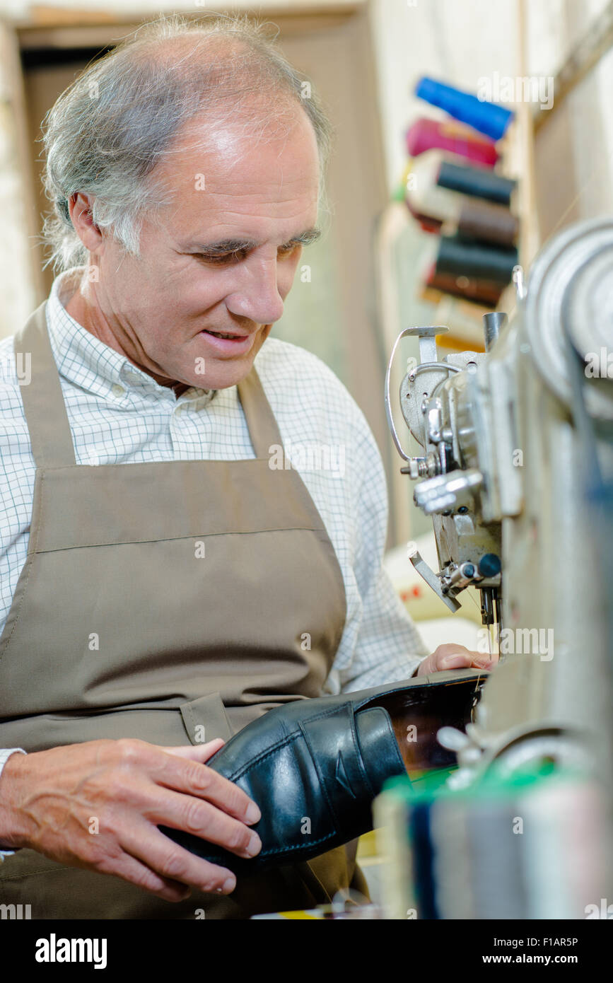 Cobbler in his workshop Stock Photo - Alamy