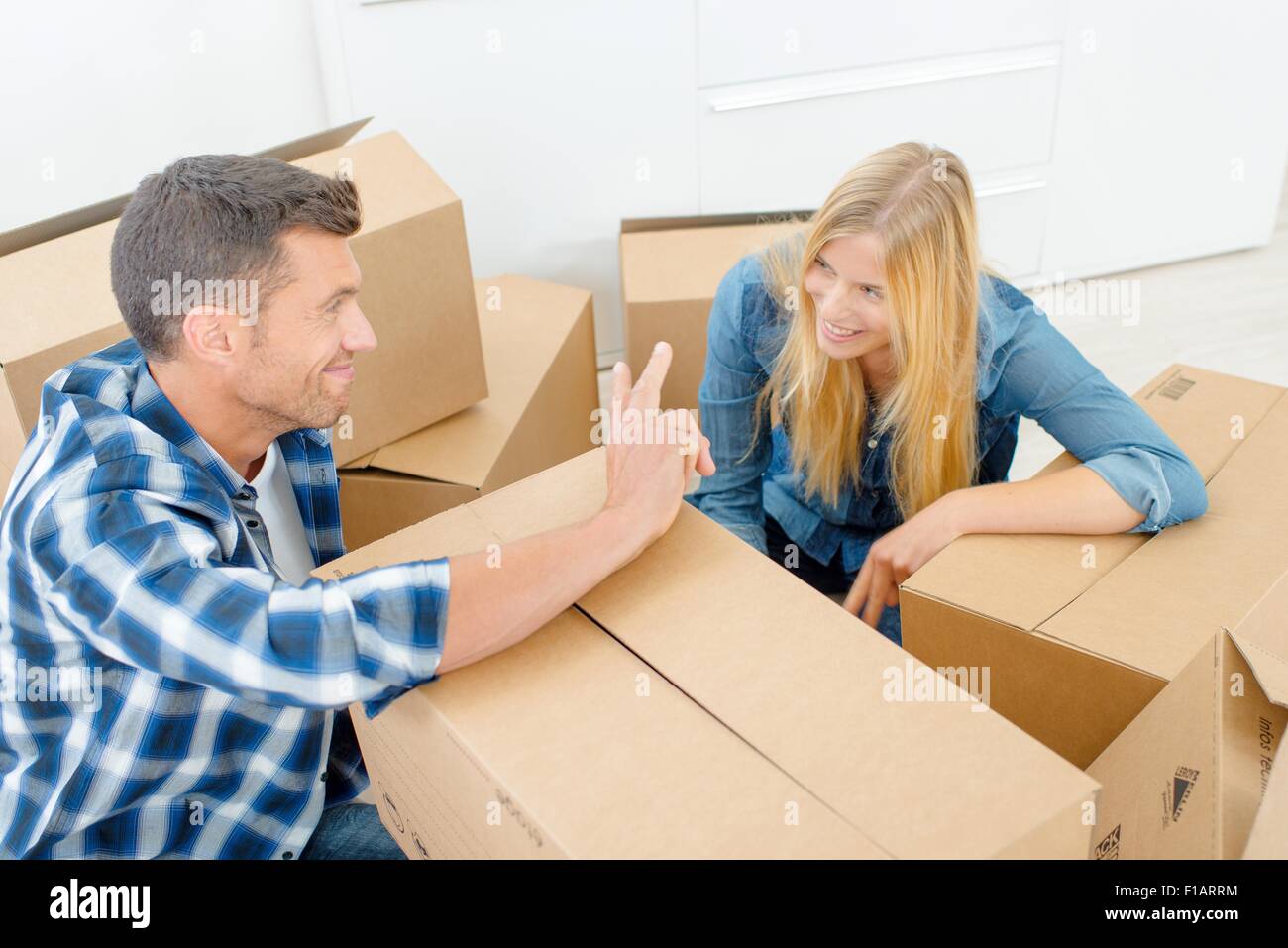 Tired couple are moving house Stock Photo - Alamy