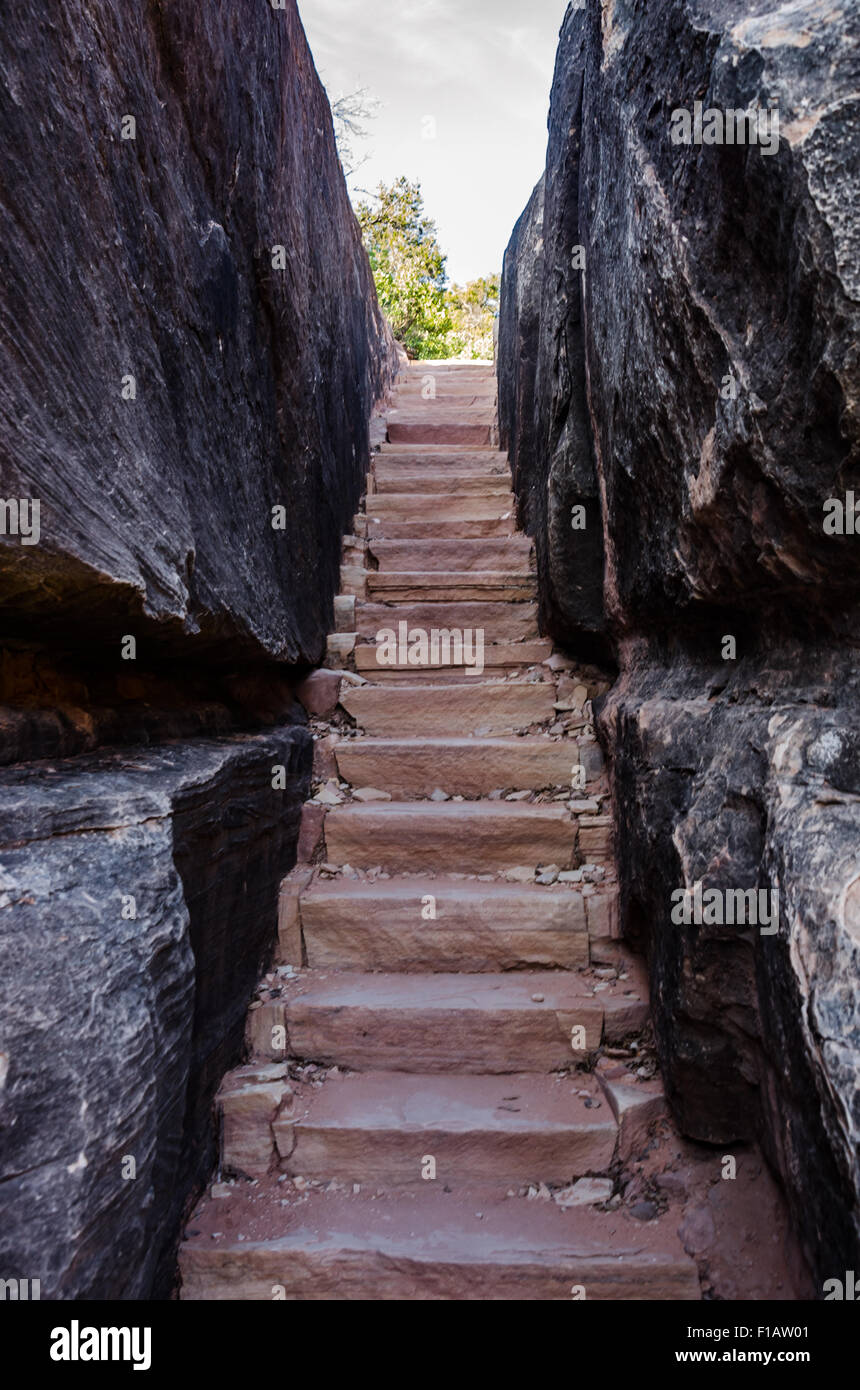 A sandstone staircase leads hikers out of a long slot canyon along the ...