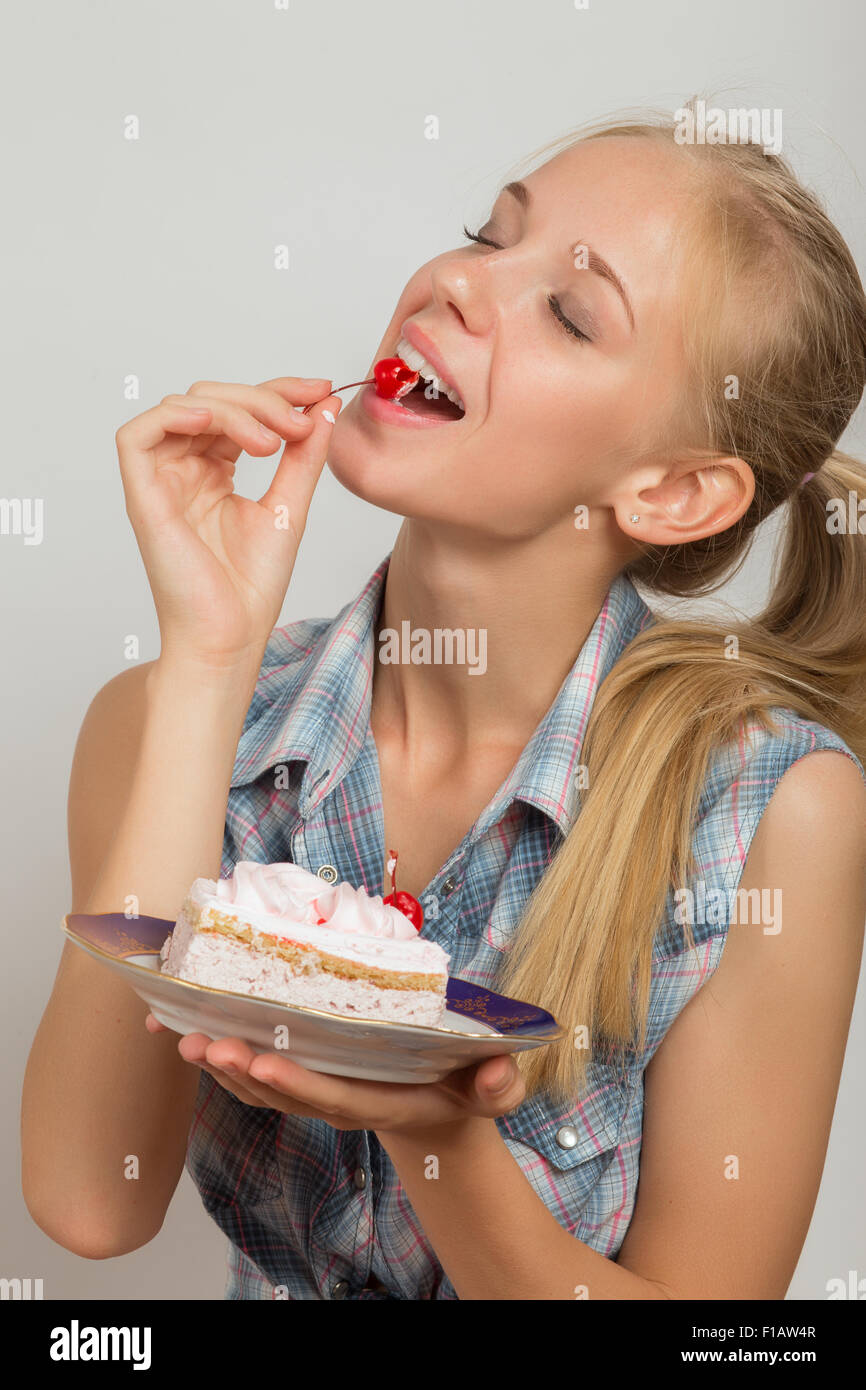 happy woman eating cherry dessert Stock Photo - Alamy