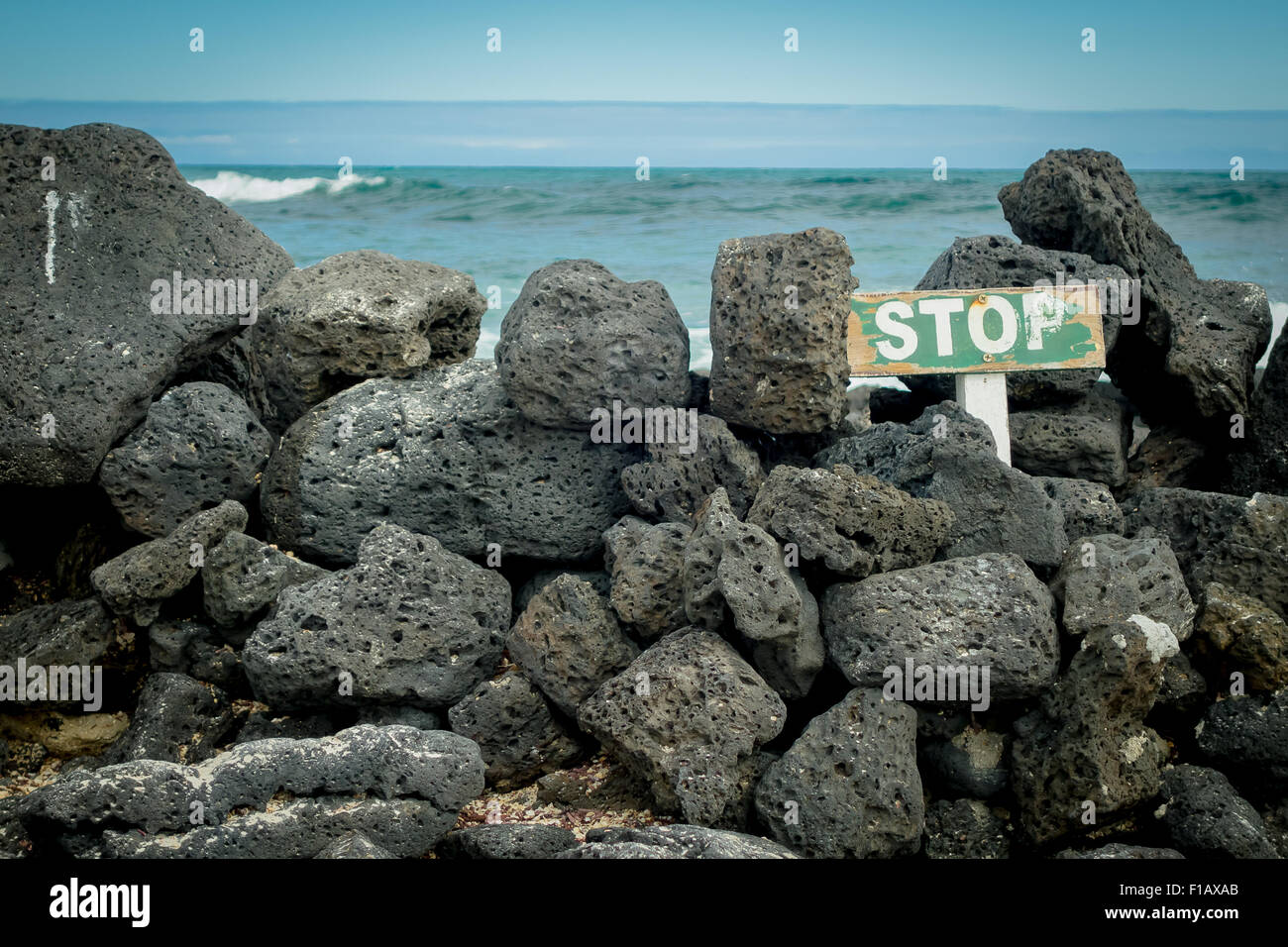 old wooden stop sign warning about a protected beach area in galapagos ...