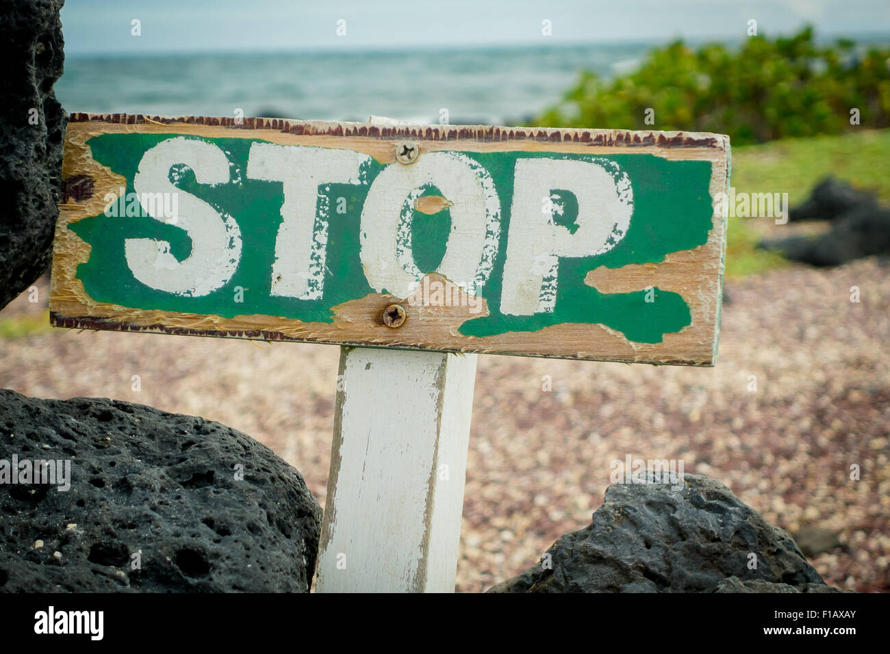 old wooden stop sign warning about a protected beach area in galapagos ...