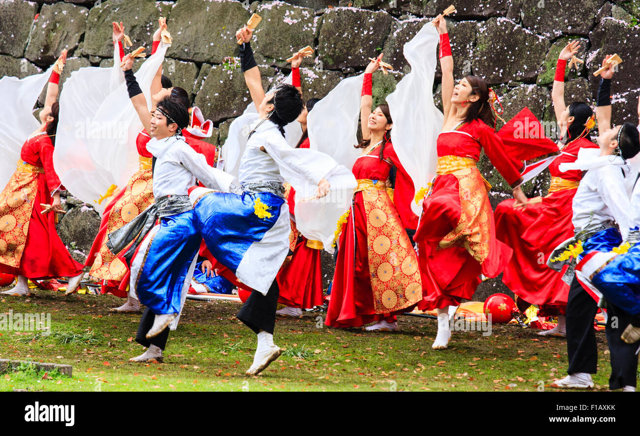 Japanese yosakoi dance team dancing in front of castle stone wall ...