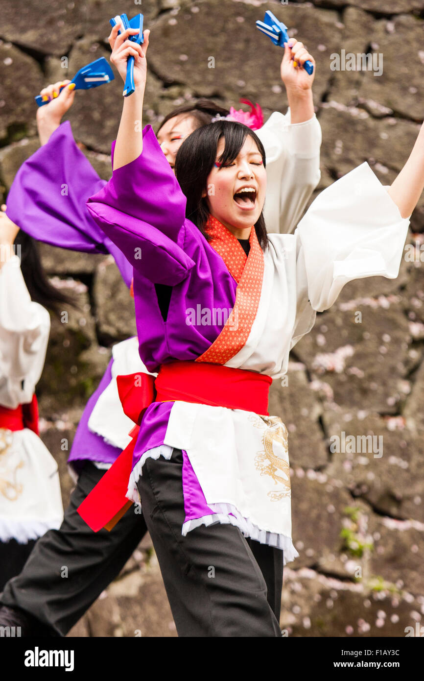 Japanese yosakoi dance festival at Kumamoto. Young women, holding ...