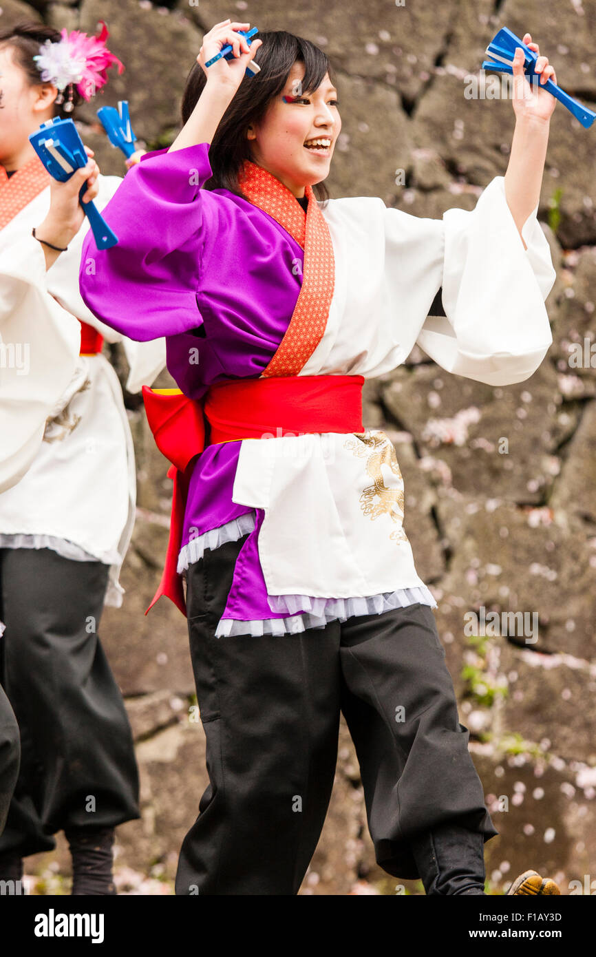 Japanese yosakoi dance festival at Kumamoto. Young women, holding ...