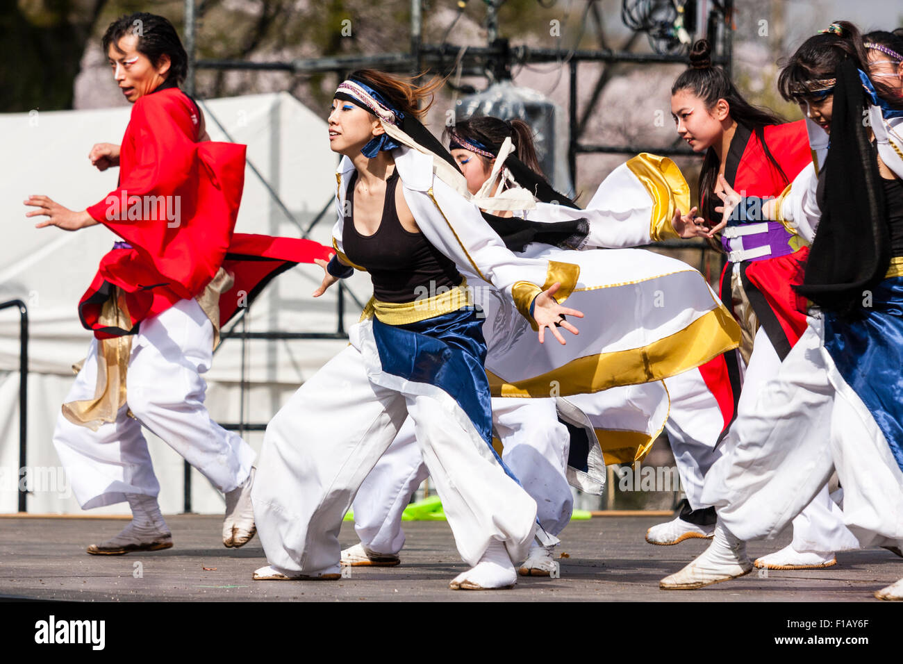 Japanese yosakoi dance team on stage dancing while wearing happi coats ...