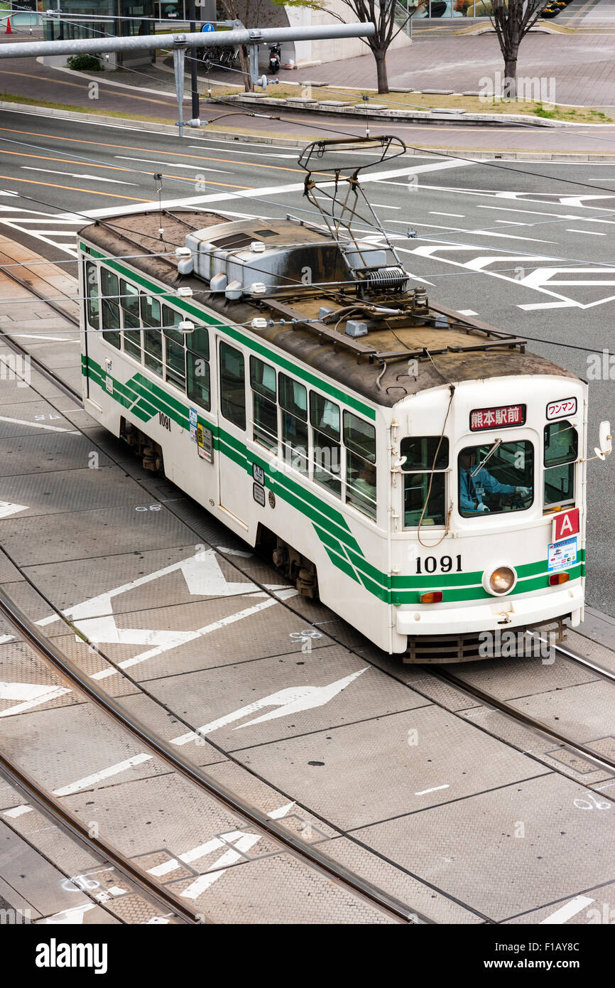 Japanese street tram in the city of Kumamoto. Overhead view of single ...