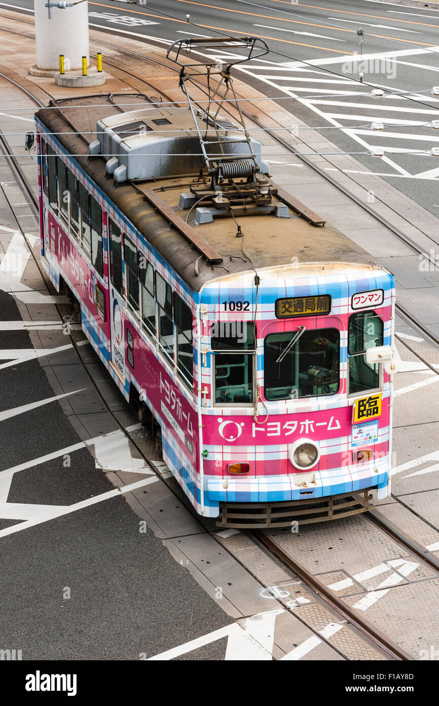Japanese street tram in the city of Kumamoto. Overhead view of single ...