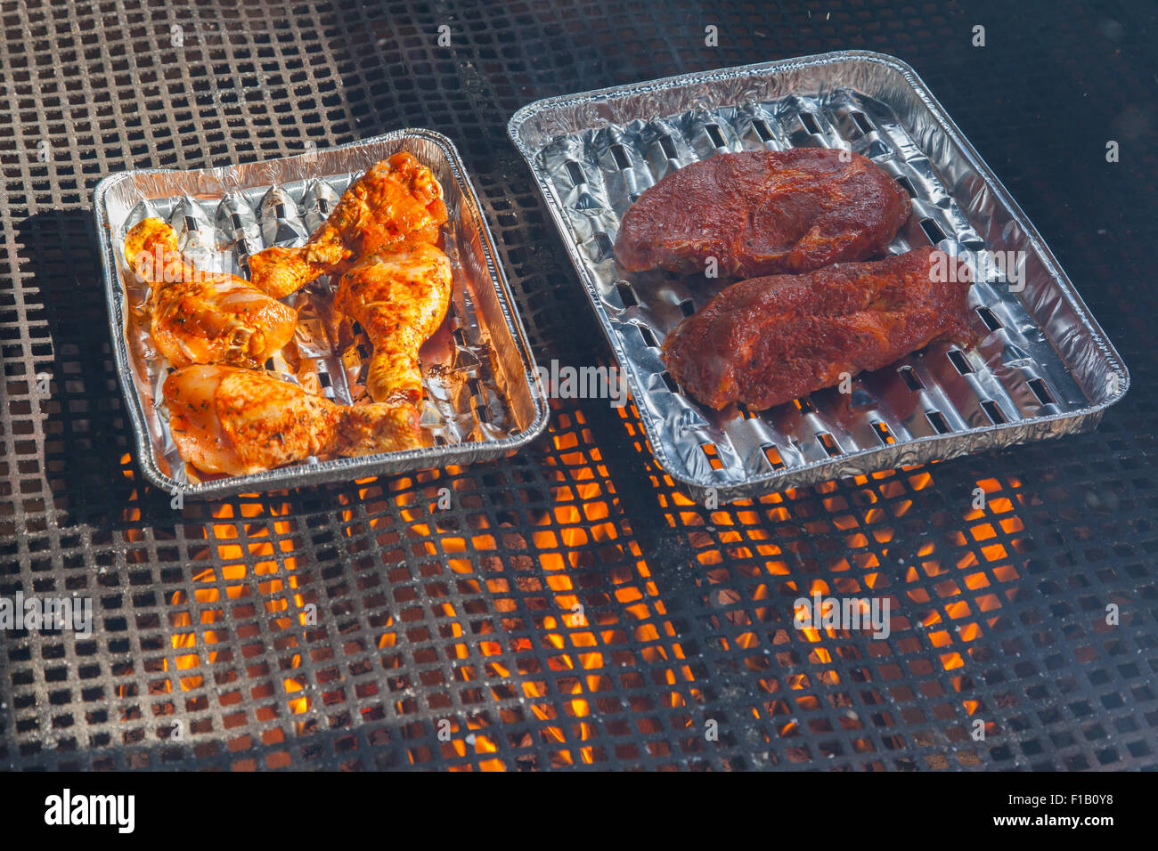 Meat getting ready on a large bbq Stock Photo - Alamy