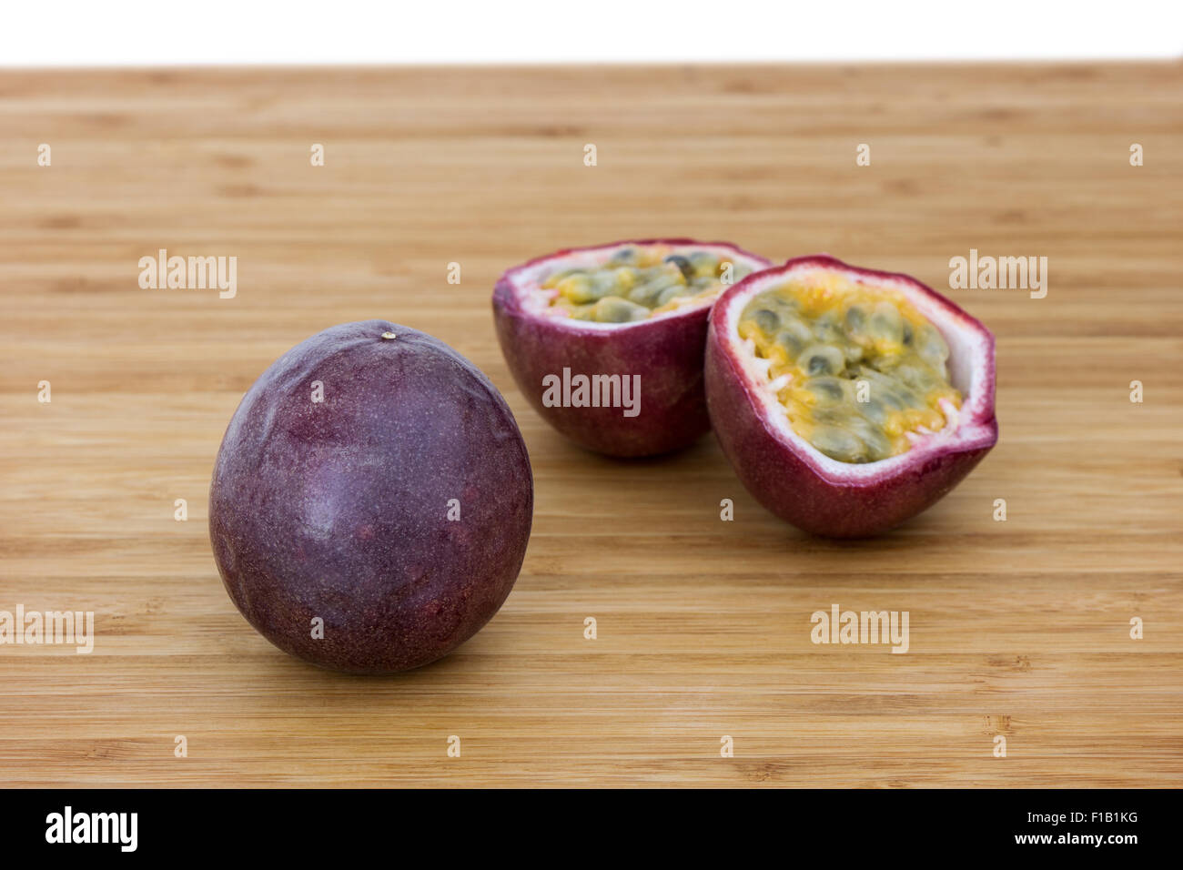 Close-up of a whole and split passion fruits (passionfruit, purple ...