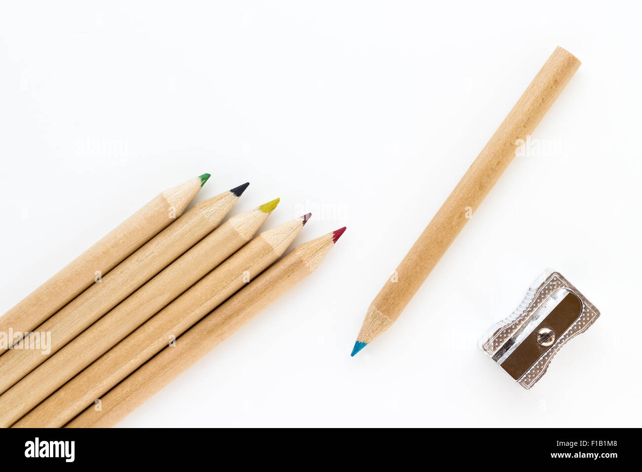 Group of crayons and pencil sharpener on white background and seen from ...