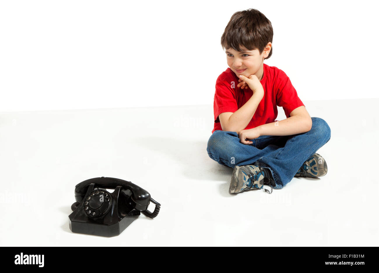 little boy expecting a phone call Stock Photo - Alamy