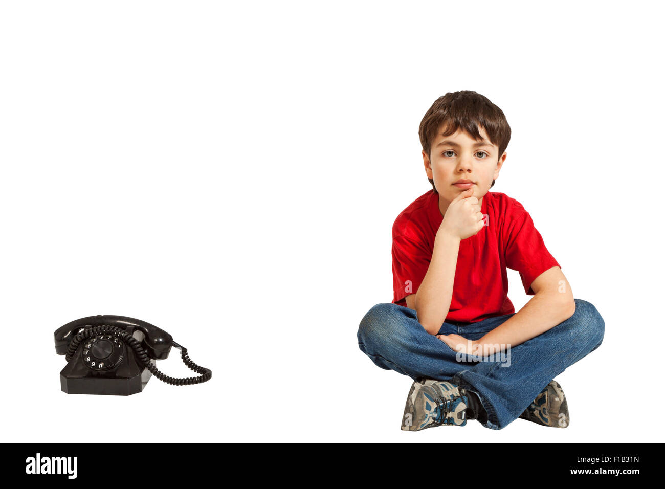 little boy expecting a phone call Stock Photo - Alamy