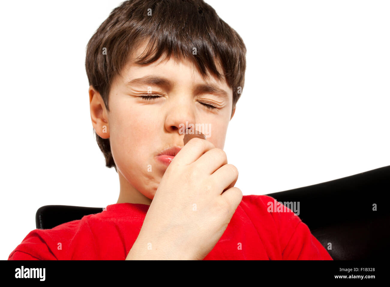 little boy eating a chocolate stick, isolated on white background Stock ...