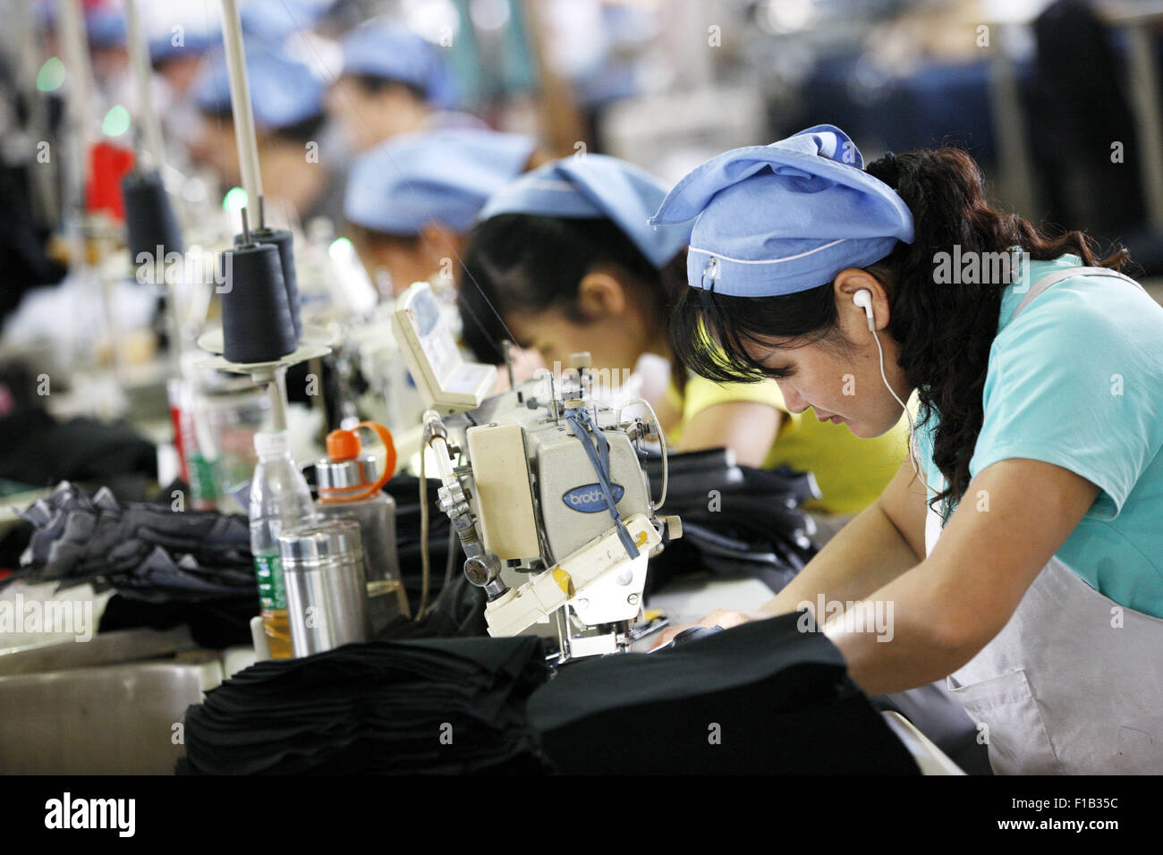 Huaibei, China. 01st Sep, 2015. A female labour works in a textile ...