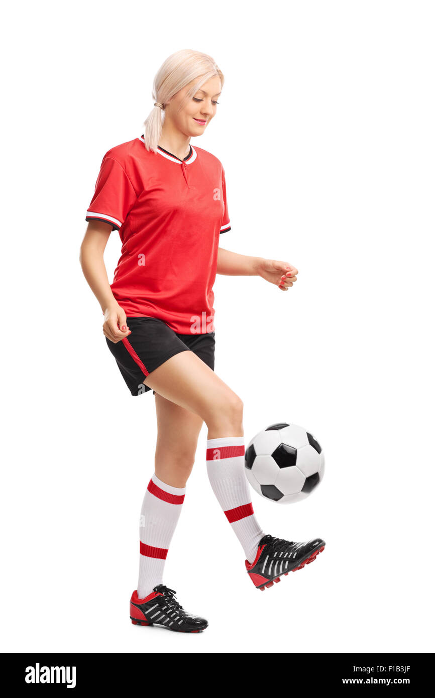 Full length portrait of a female soccer player juggling a ball and ...