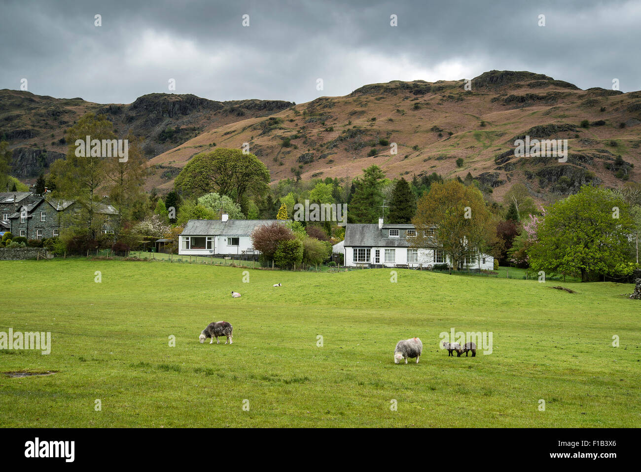 Beautiful old village landscape nestled amongst hills in Lake District ...