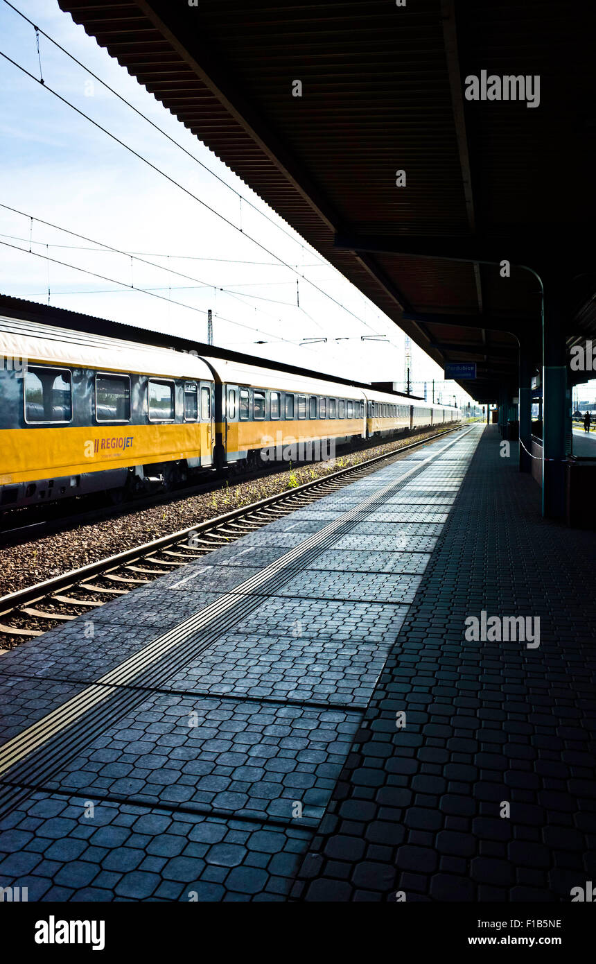 railway platform and a train waiting to leave Stock Photo - Alamy