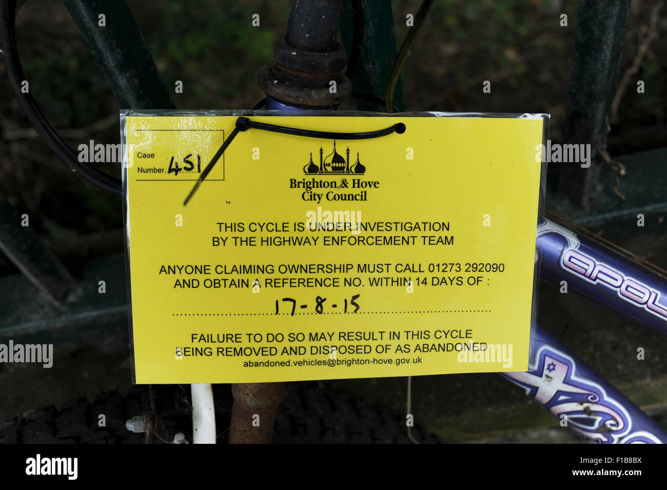 Abandoned bicycles in a Brighton street with warning notice from ...