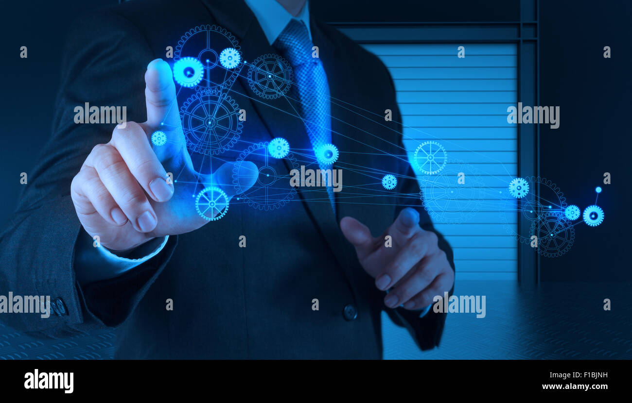 businessman hand pointing to the gear to success as concept Stock Photo ...