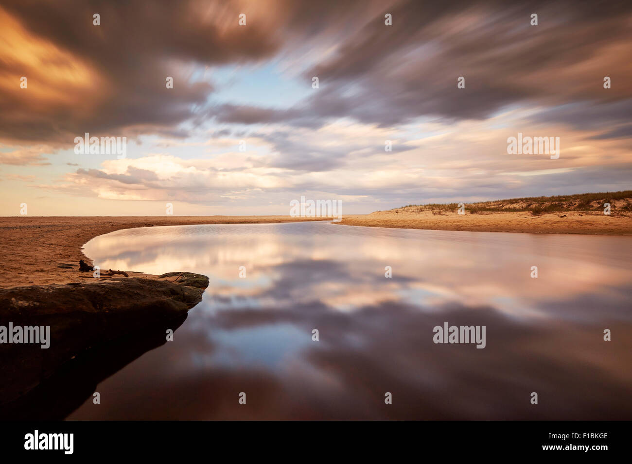Reflection of late afternoon clouds at Castaways Beach, Queensland ...