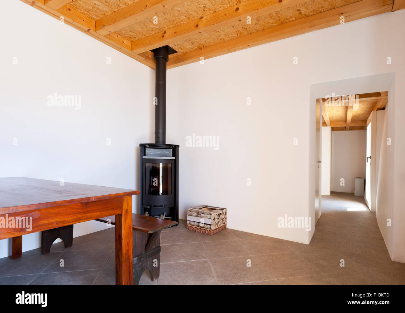 room with table and wood stove, rural home interior Stock Photo - Alamy