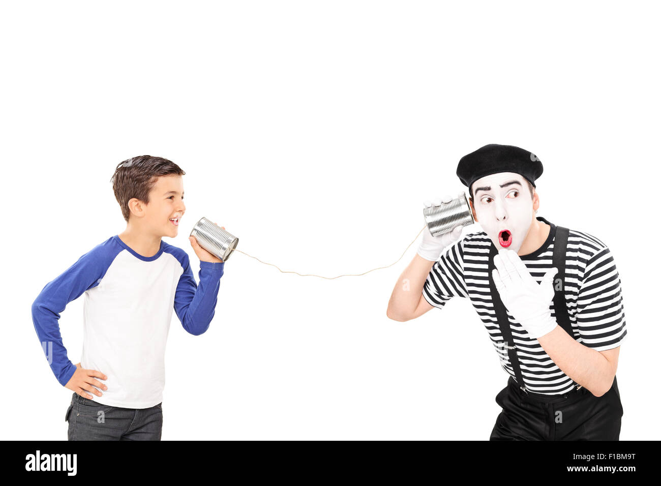 Studio shot of a little kid talking to a young male comedian through a ...