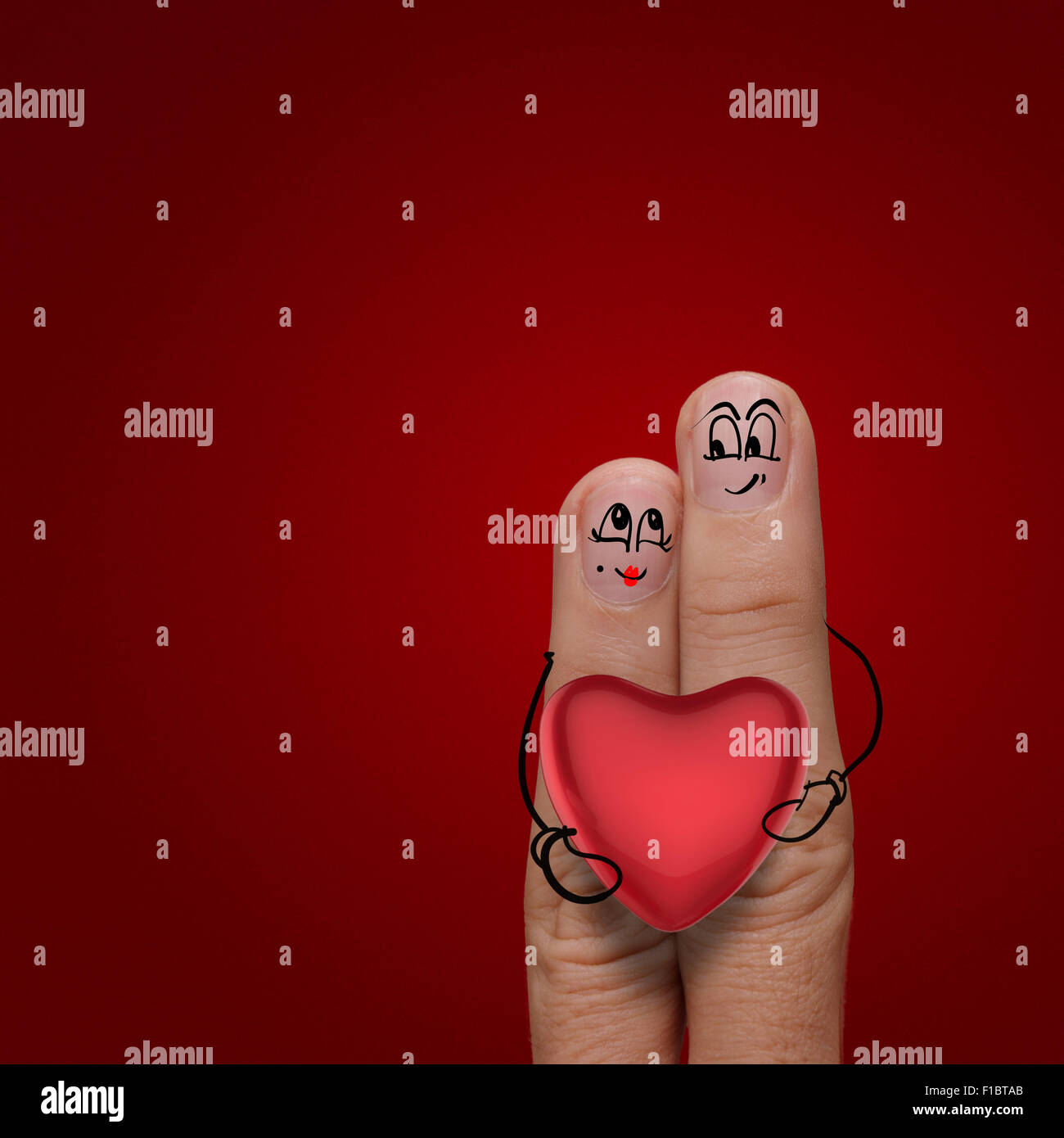 the happy finger couple in love with painted smiley and hold heart ...