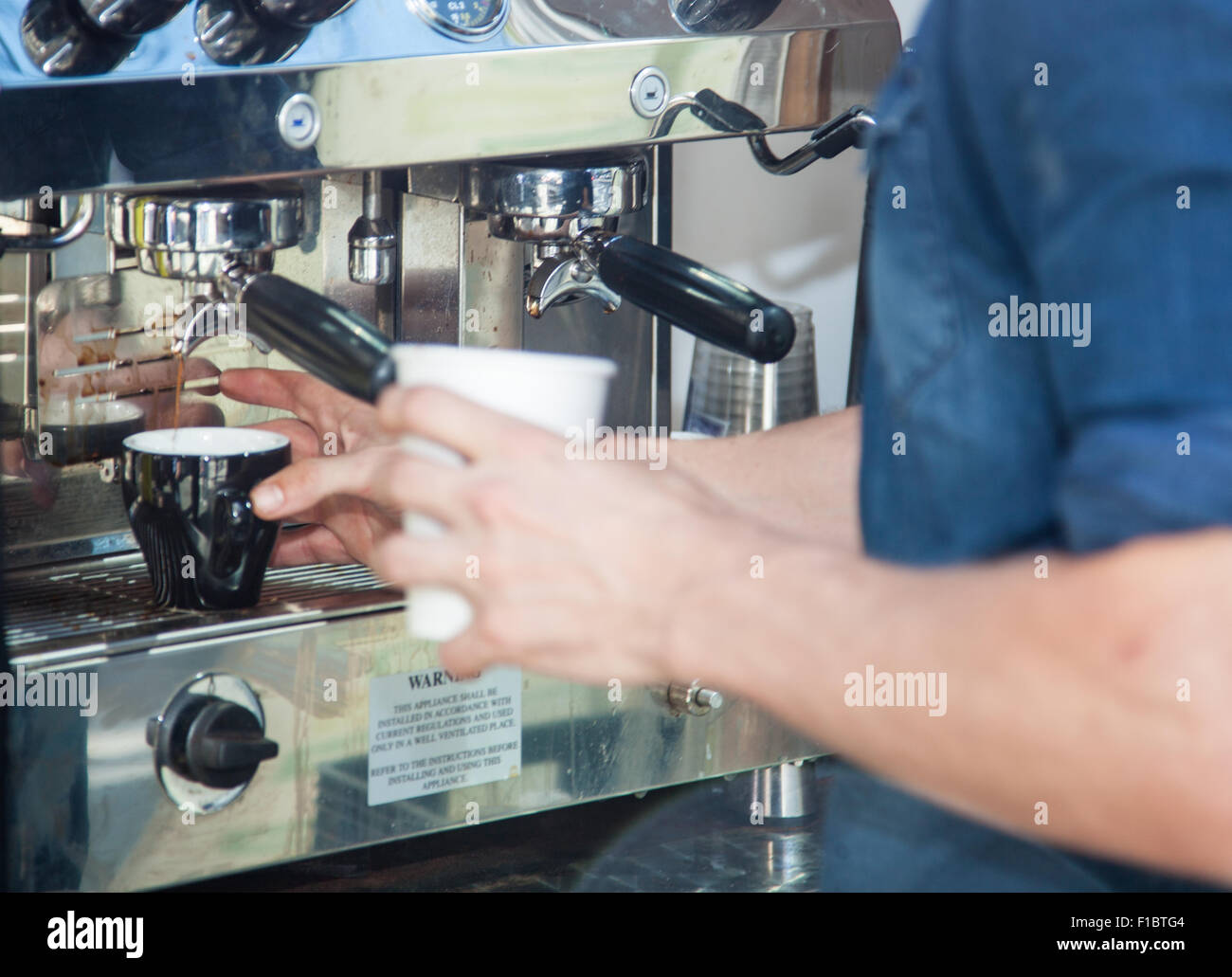 Barista making fine italian coffee Stock Photo - Alamy