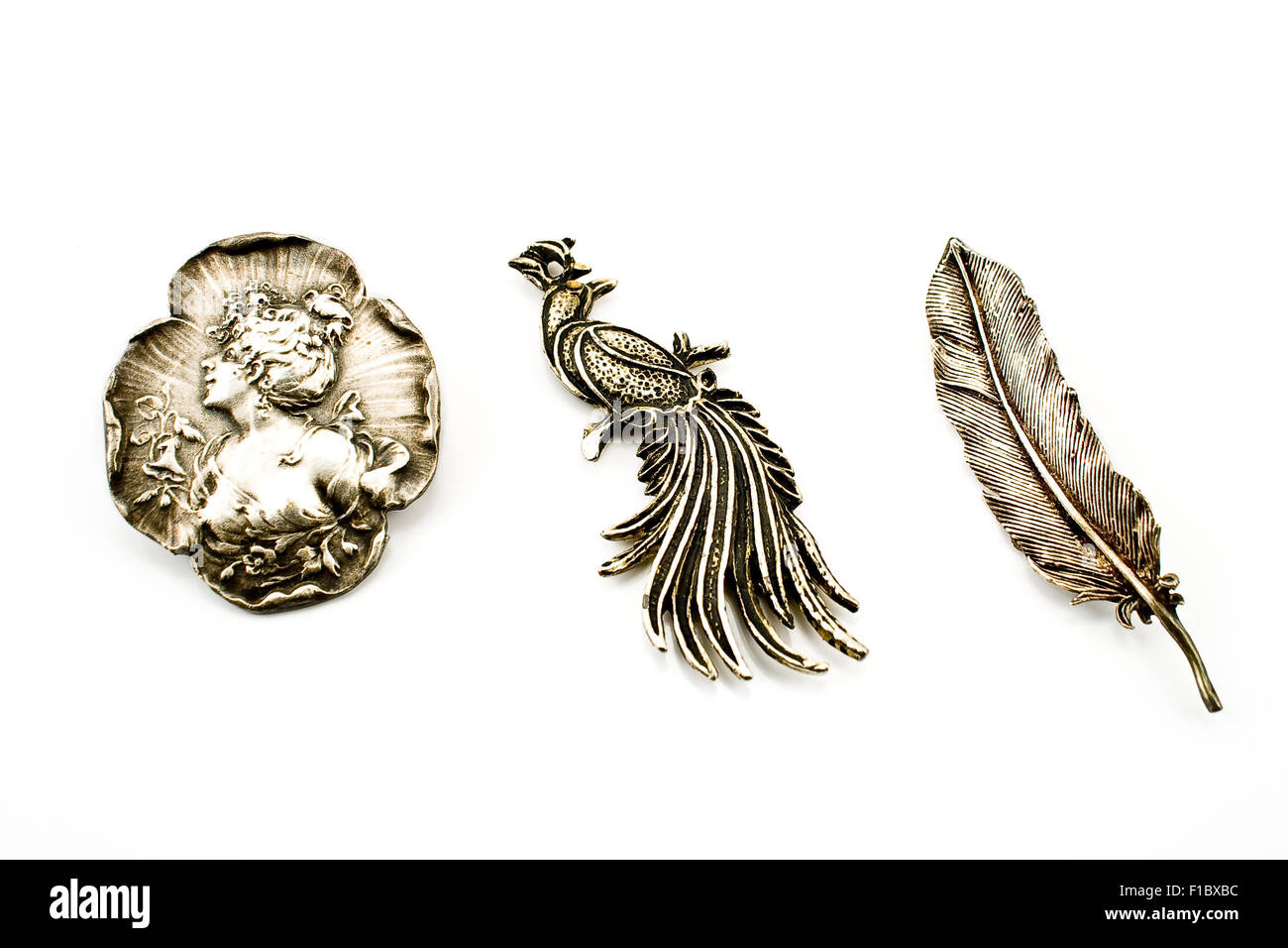 Three antique silver brooches isolated on white Stock Photo - Alamy
