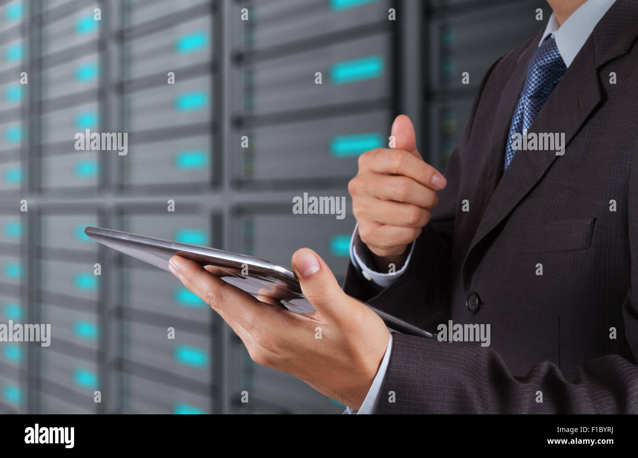 businessman hand using tablet computer and server room background Stock ...