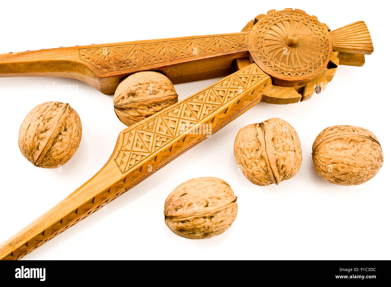 Antique carved wooden nutcracker with walnuts isolated on white Stock ...