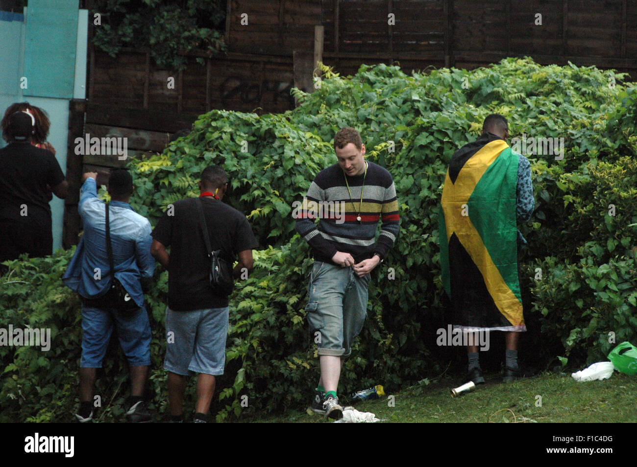 London, UK, 31 August 2015, men urinate at Notting Hill carnival ...