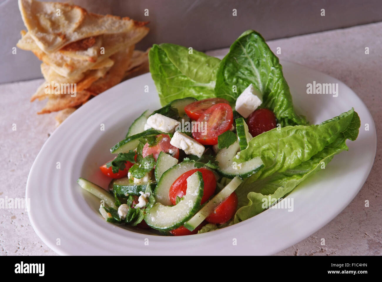 Greek salad with pitta crisps Stock Photo - Alamy