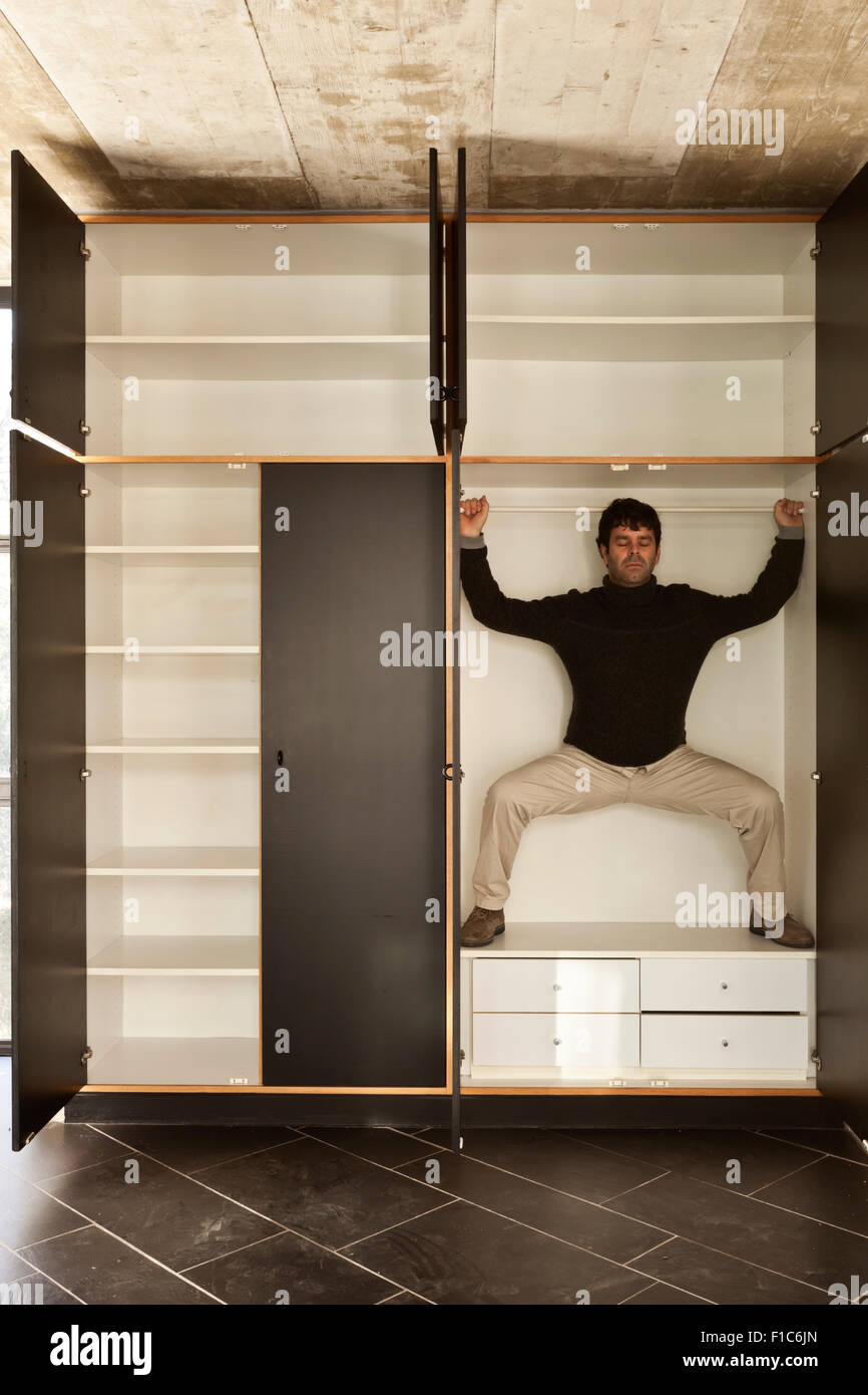 room with wardrobe, man inside Stock Photo - Alamy