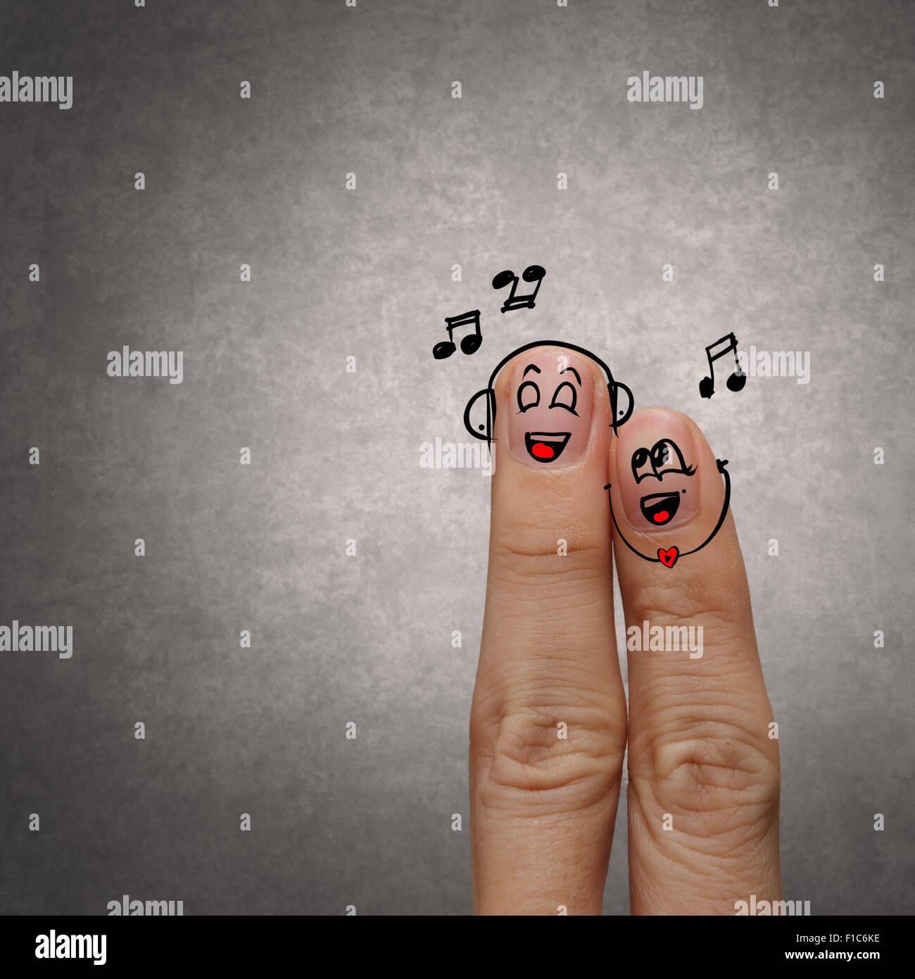 A happy finger couple in love with painted smiley and sing a song Stock ...