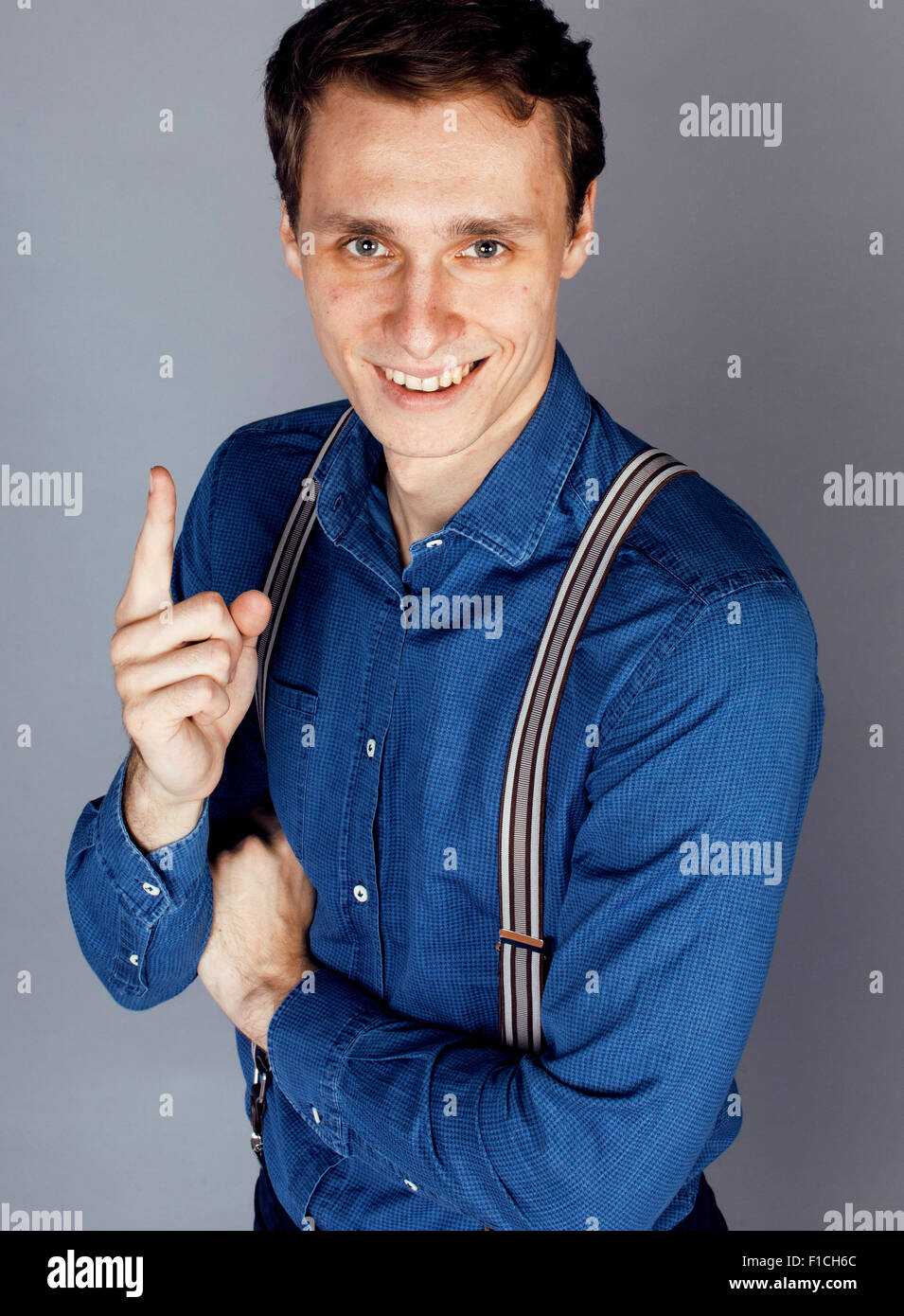 young goofy man with pimples pointing in studio Stock Photo - Alamy
