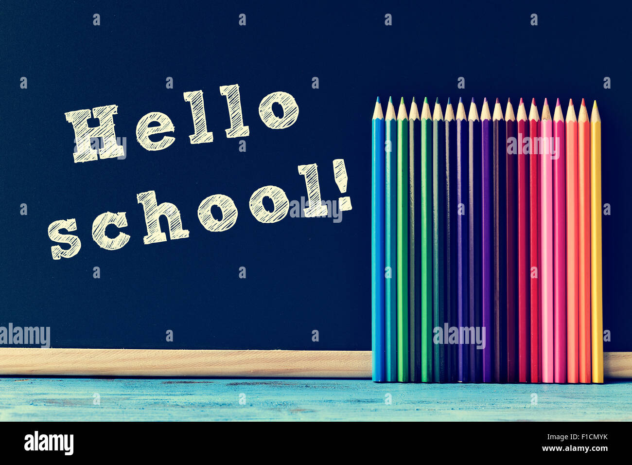 the ext hello school written on a chalkboard and a pile of pencil ...