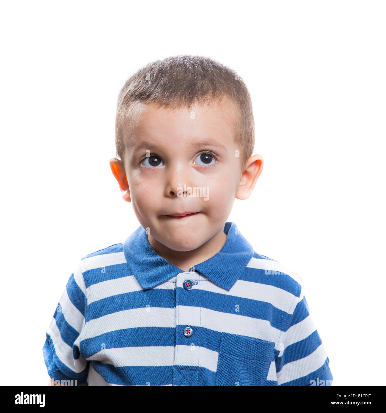 Portrait of dubious beautiful little boy isolated on white background ...