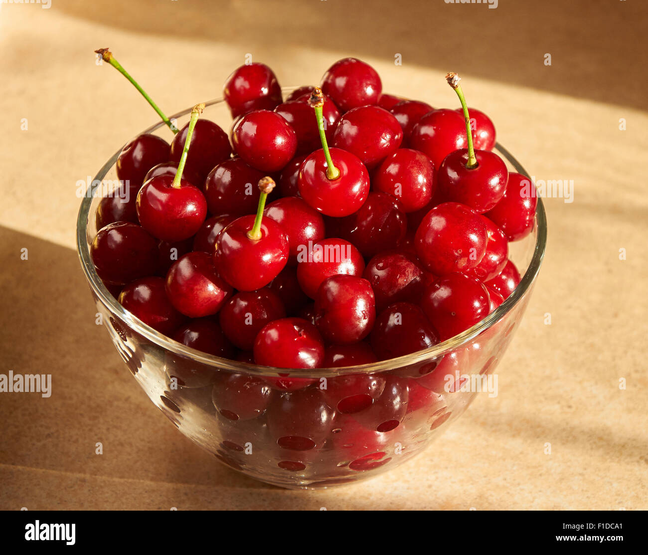 glass bowl full of wet red ripe cherries Stock Photo - Alamy